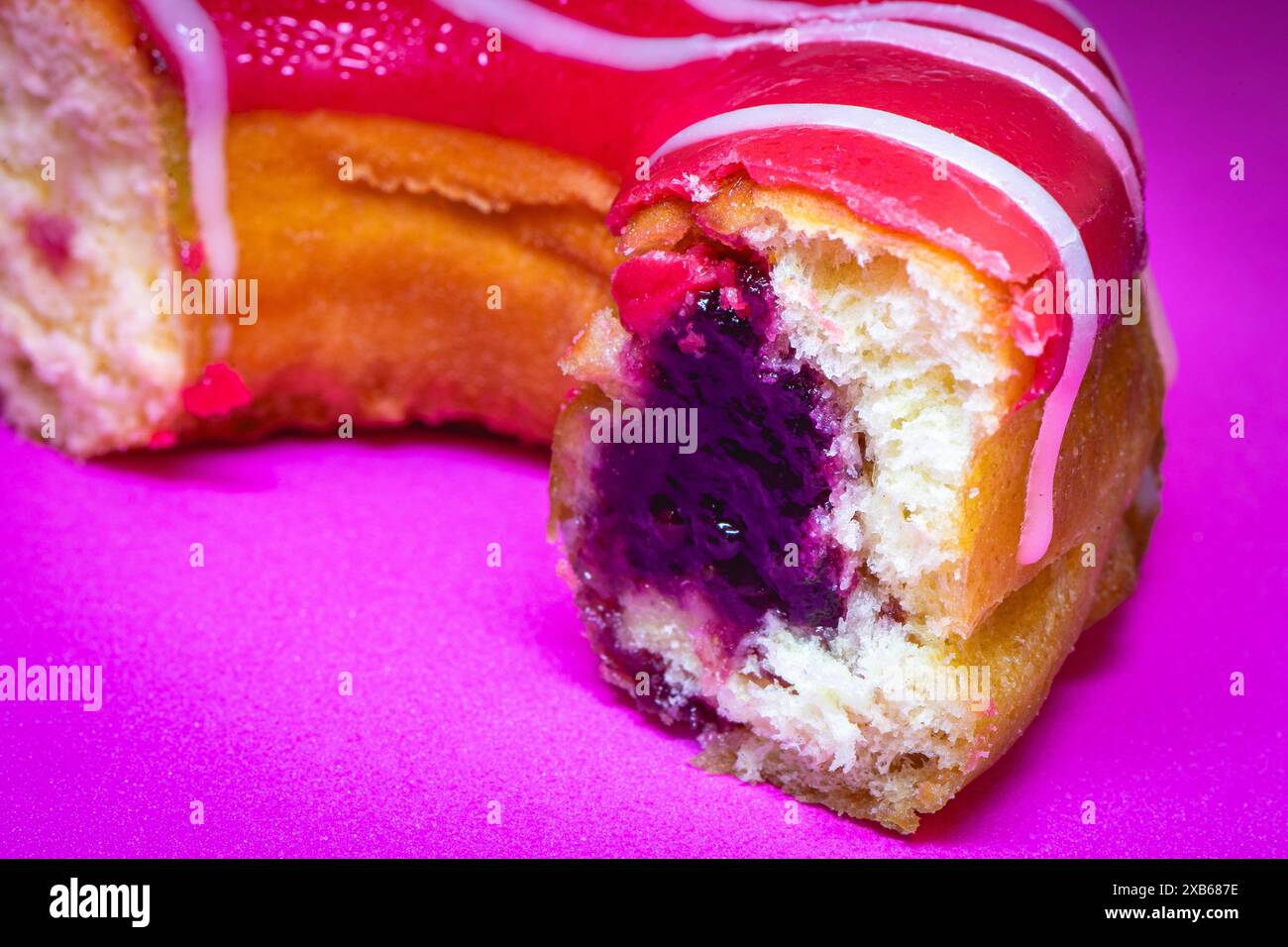 Close up from a donut with Jam inside, on a purple background Stock ...