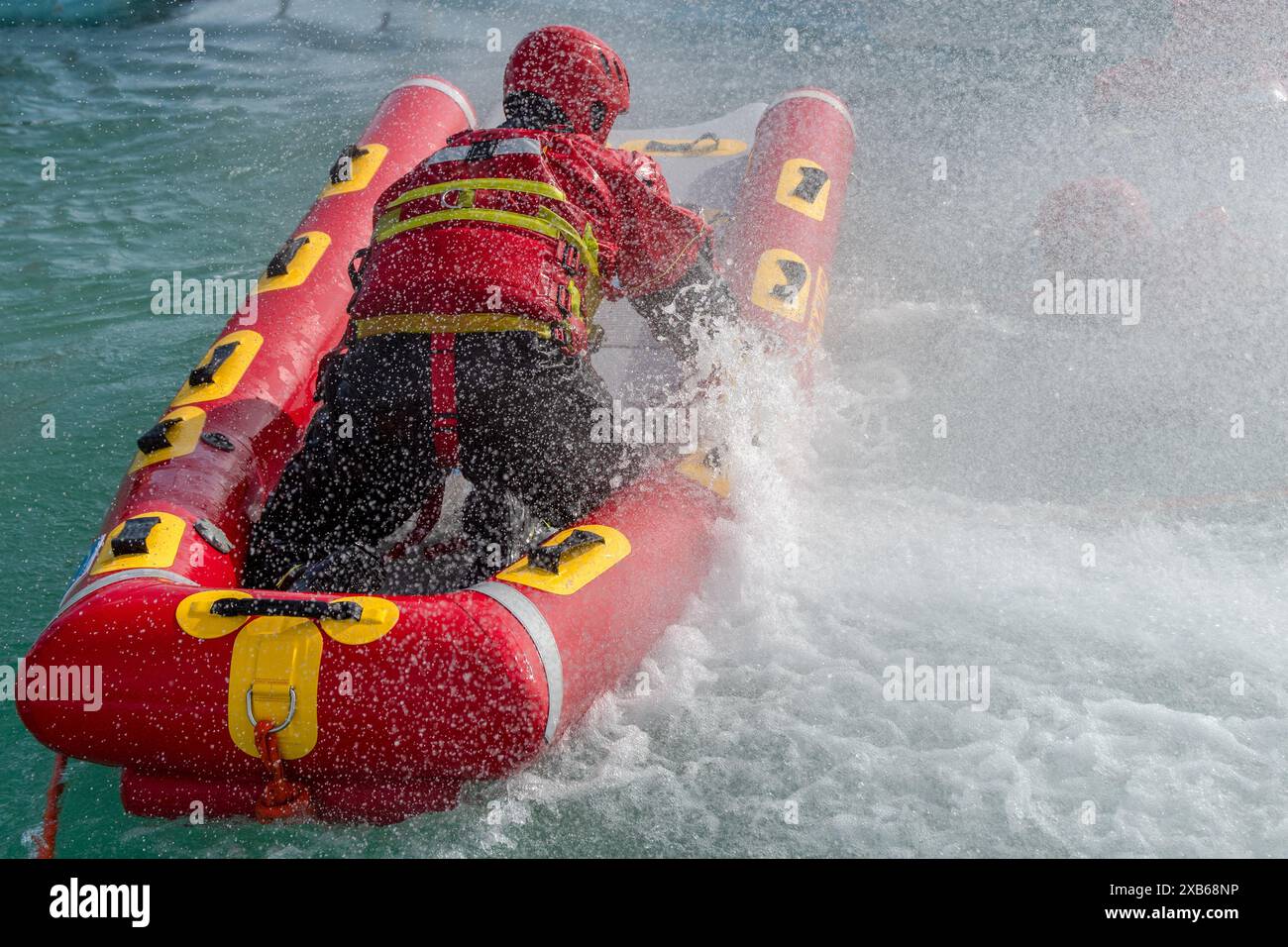 firefighters in water rescue drill, using canoe and special suits ...