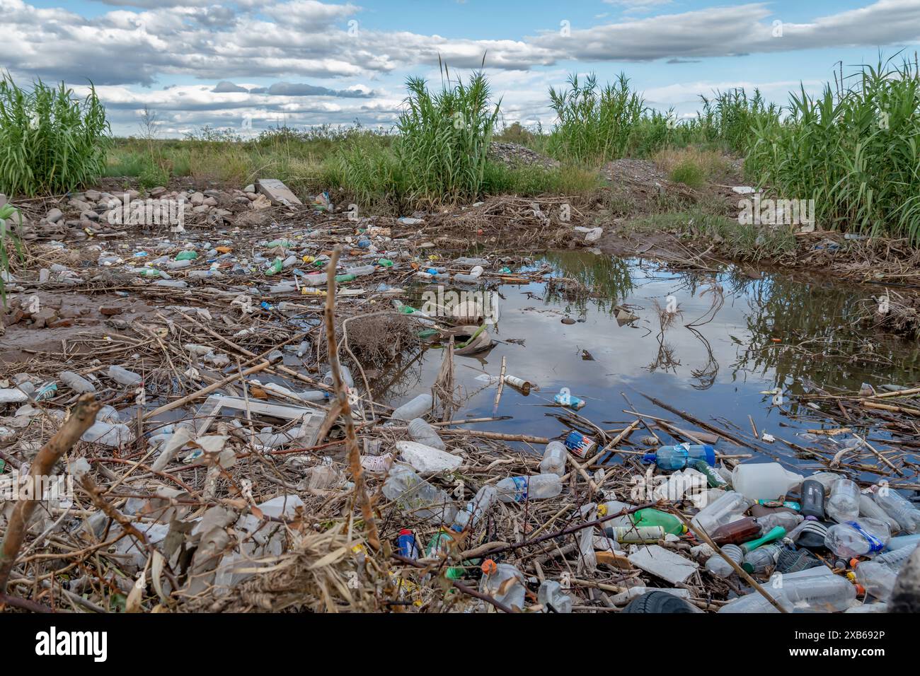 San Rafael, Argentina, january 1, 2021:Rubbish floating on a surface of the water, contamination ...