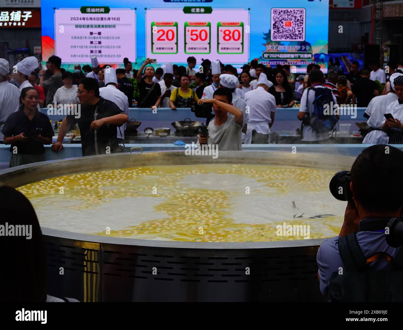 YICHANG, CHINA - JUNE 8, 2024 - Thirteen chefs cook a 3-meter-diameter ...