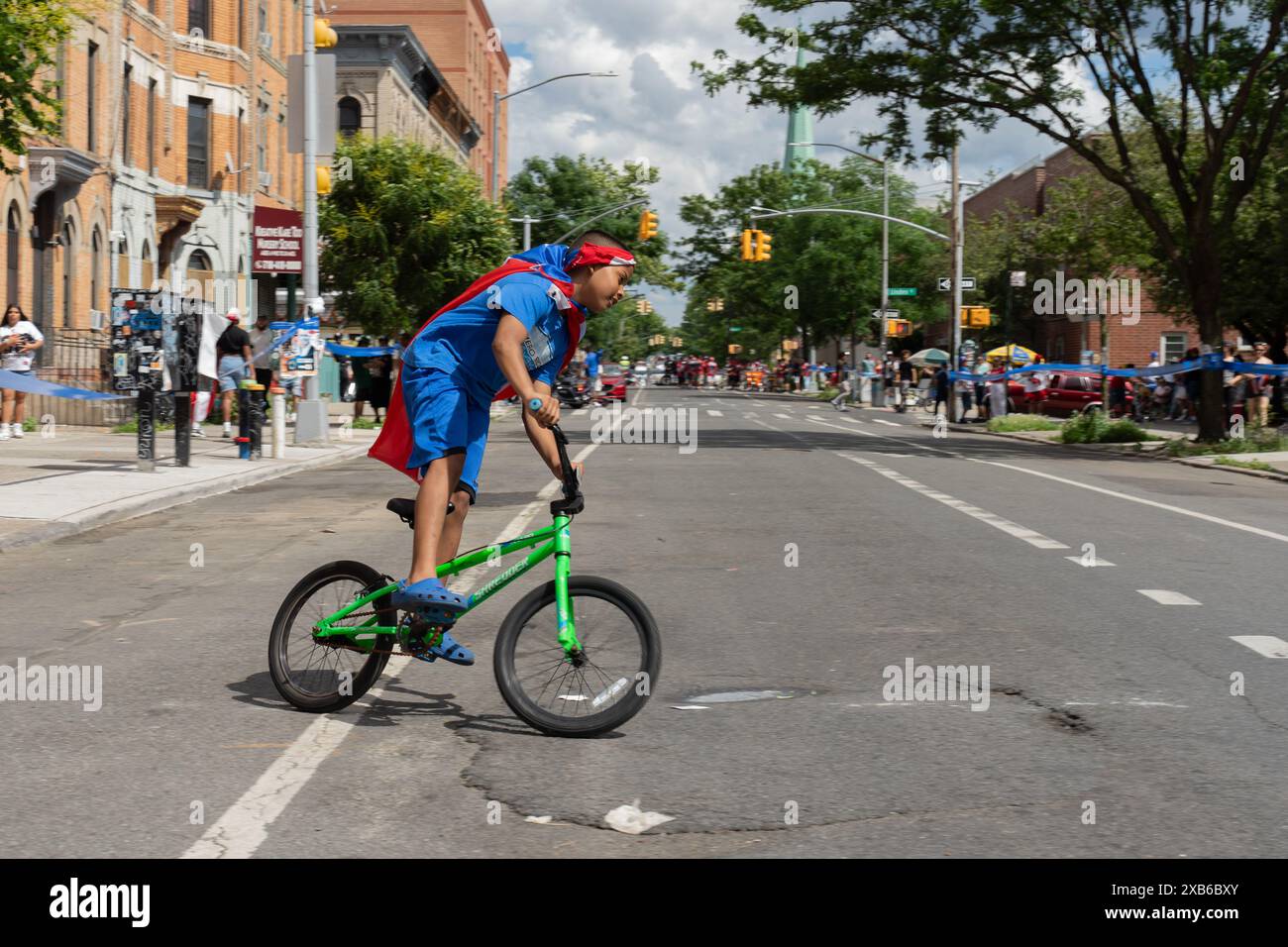 Brooklyn, United States. 09th June, 2024. A young boy rides his bike on ...
