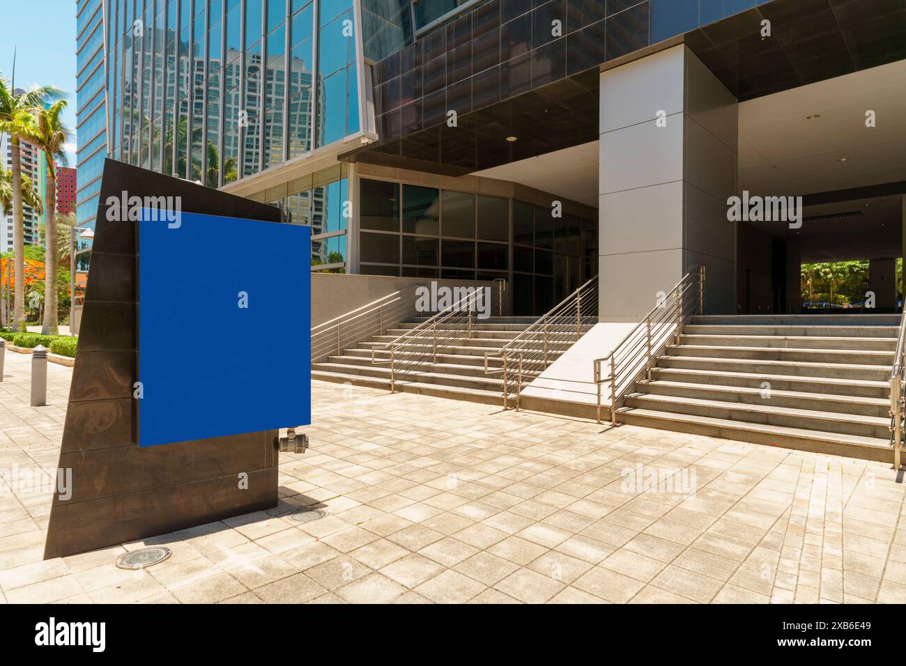Office buidling sign and steps at entrance. Blue advertising space on ...