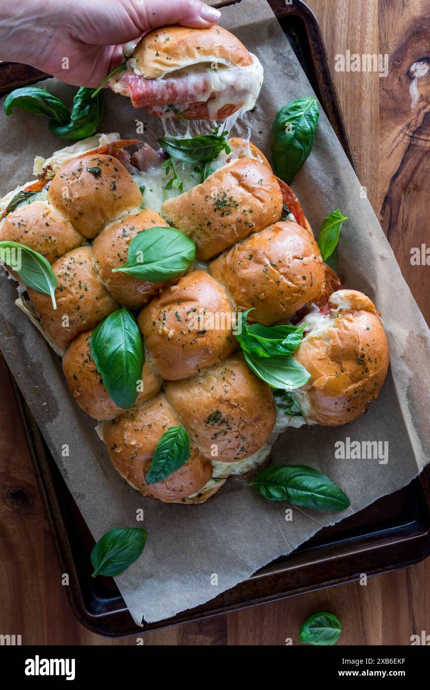A parchment lined baking sheet topped with cheesy Italian pull apart ...