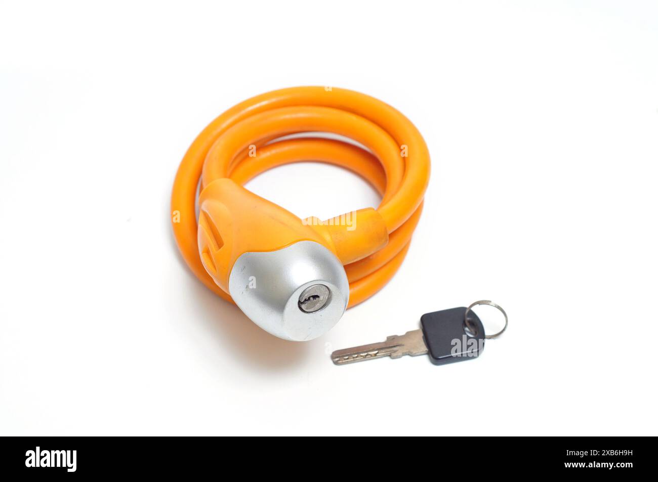 Bicycle lock yellow color and key white background Stock Photo - Alamy