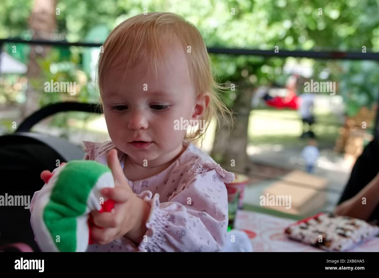 Portrait of little girl holding stuffed toy Stock Photo - Alamy
