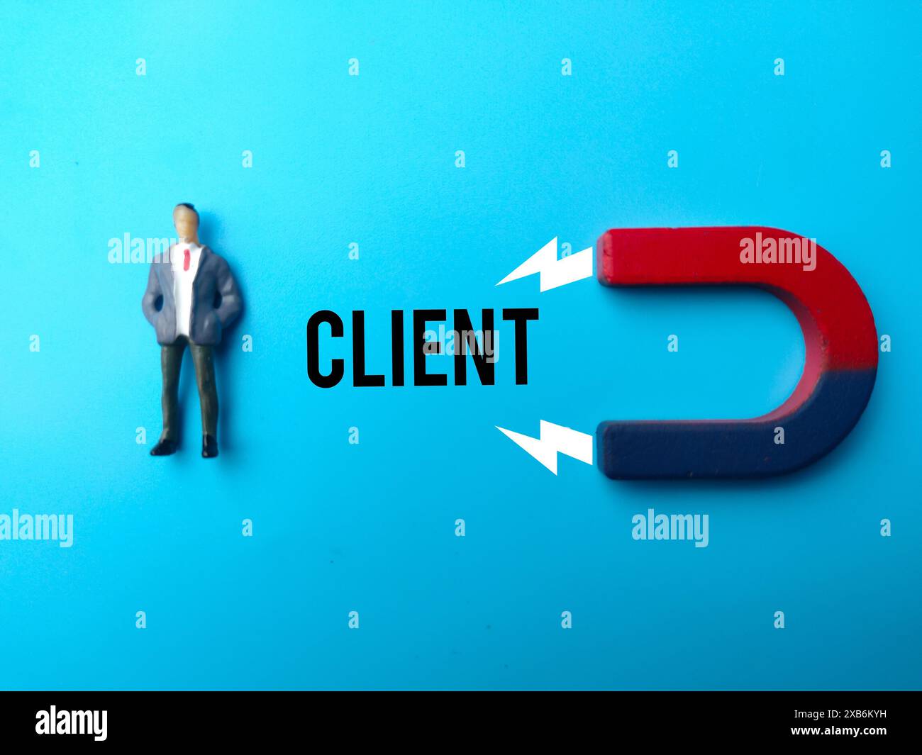 Businessman and attracts magnet with text CLIENT on blue background ...