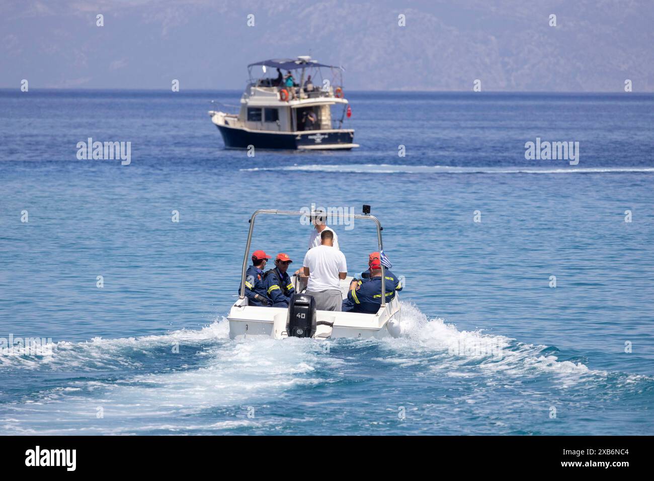 Greek Fire Services officers carrying away on a stretcher the body of ...