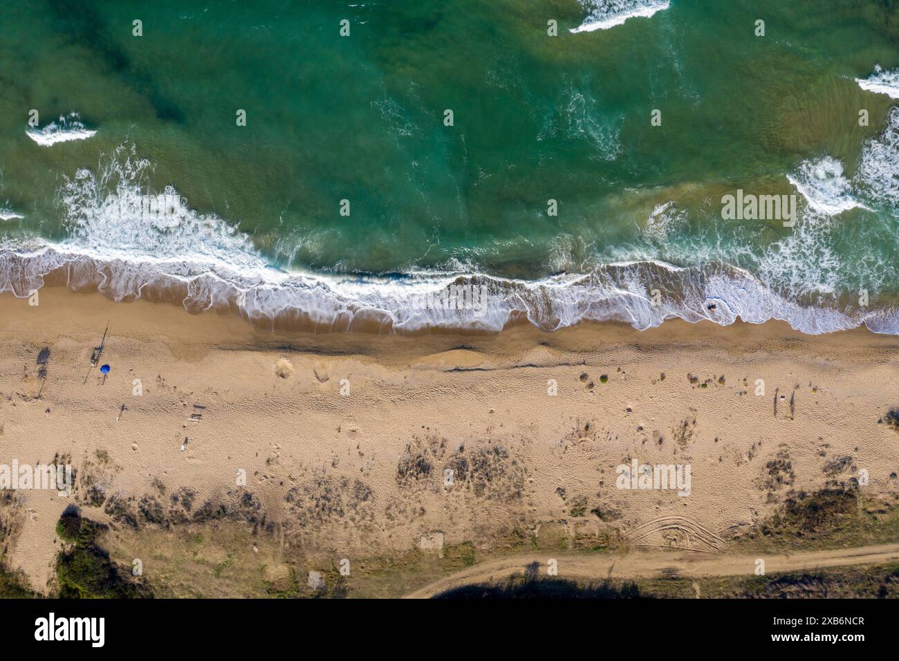 Aerial view of a remote sandy beach and sea waves by drone Stock Photo ...