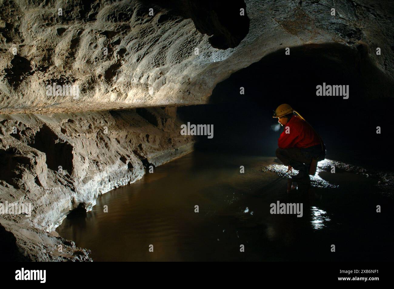 Cave explorer, spelunker, archeologist stuydying underground passage in ...