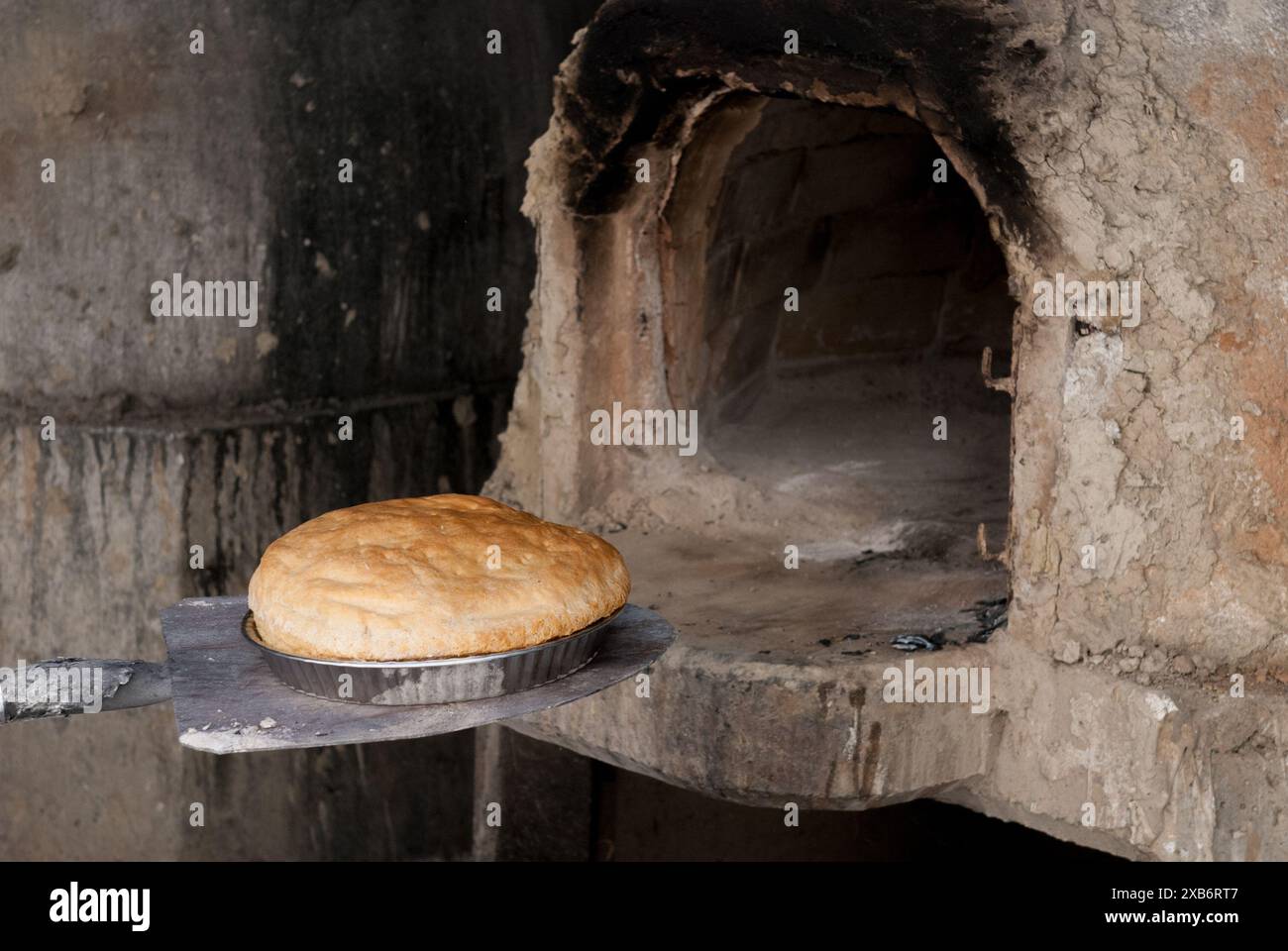 Fresh homemade bread cooked on a traditional clay oven Stock Photo - Alamy