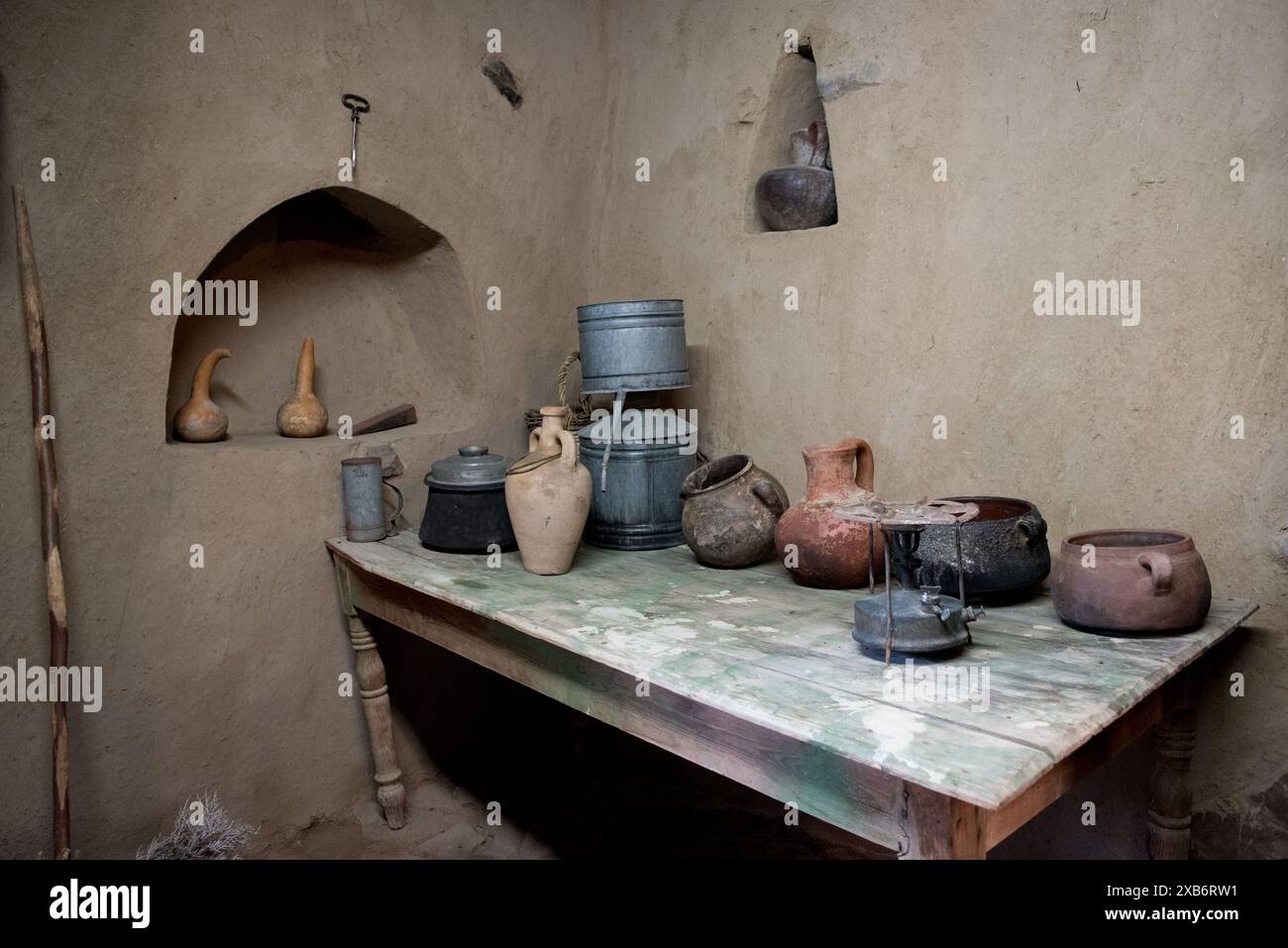 Traditional pottery and other handcraft objects on a table of an old ...