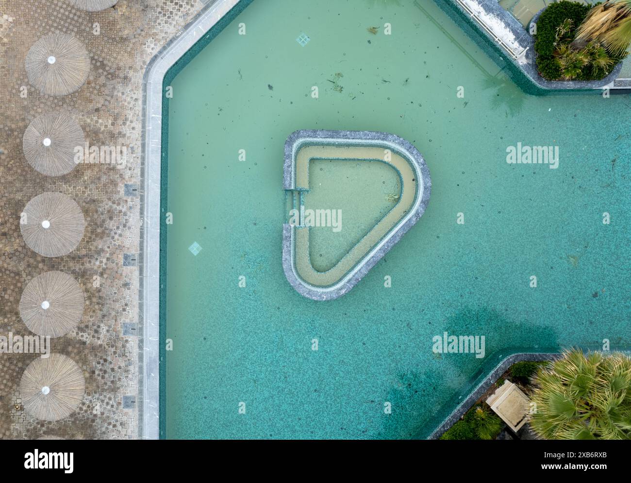Drone aerial of empty abandoned hotel swimming pool. Dirty water ...