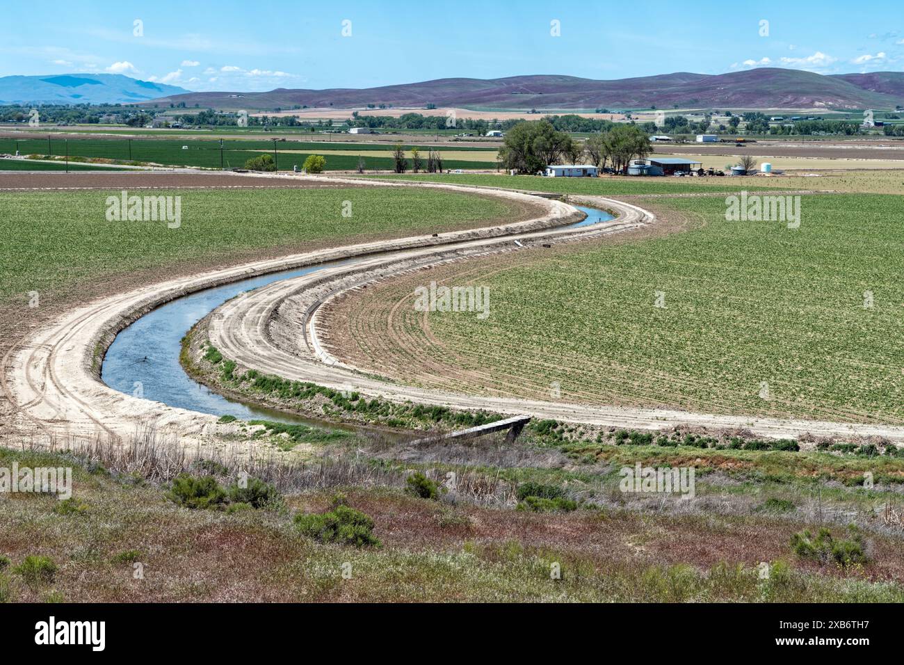 An irrigation ditch making an S-curve through farm fields in eastern ...