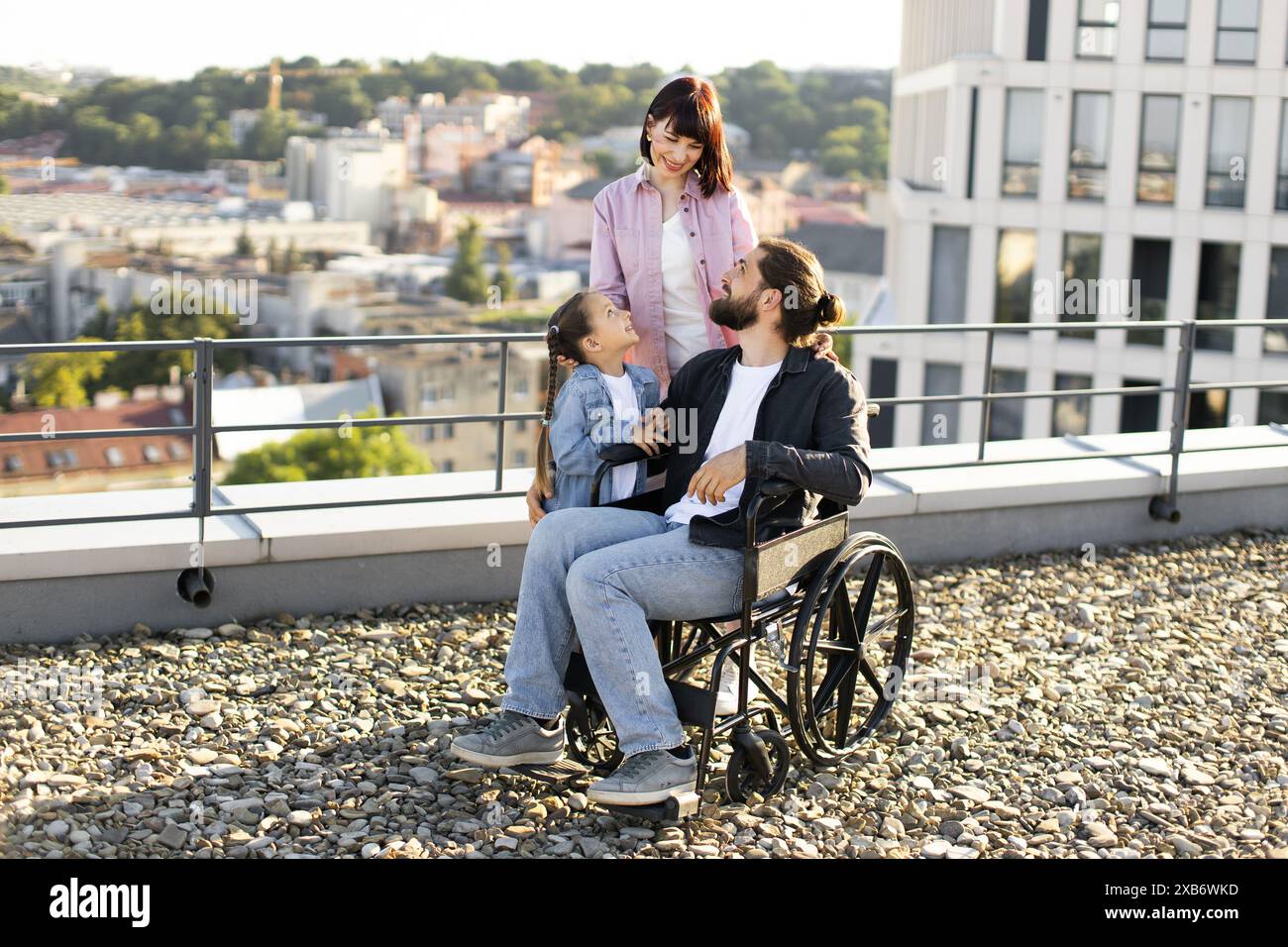 Mother and daughter support dad in treatment of serious injury Stock ...