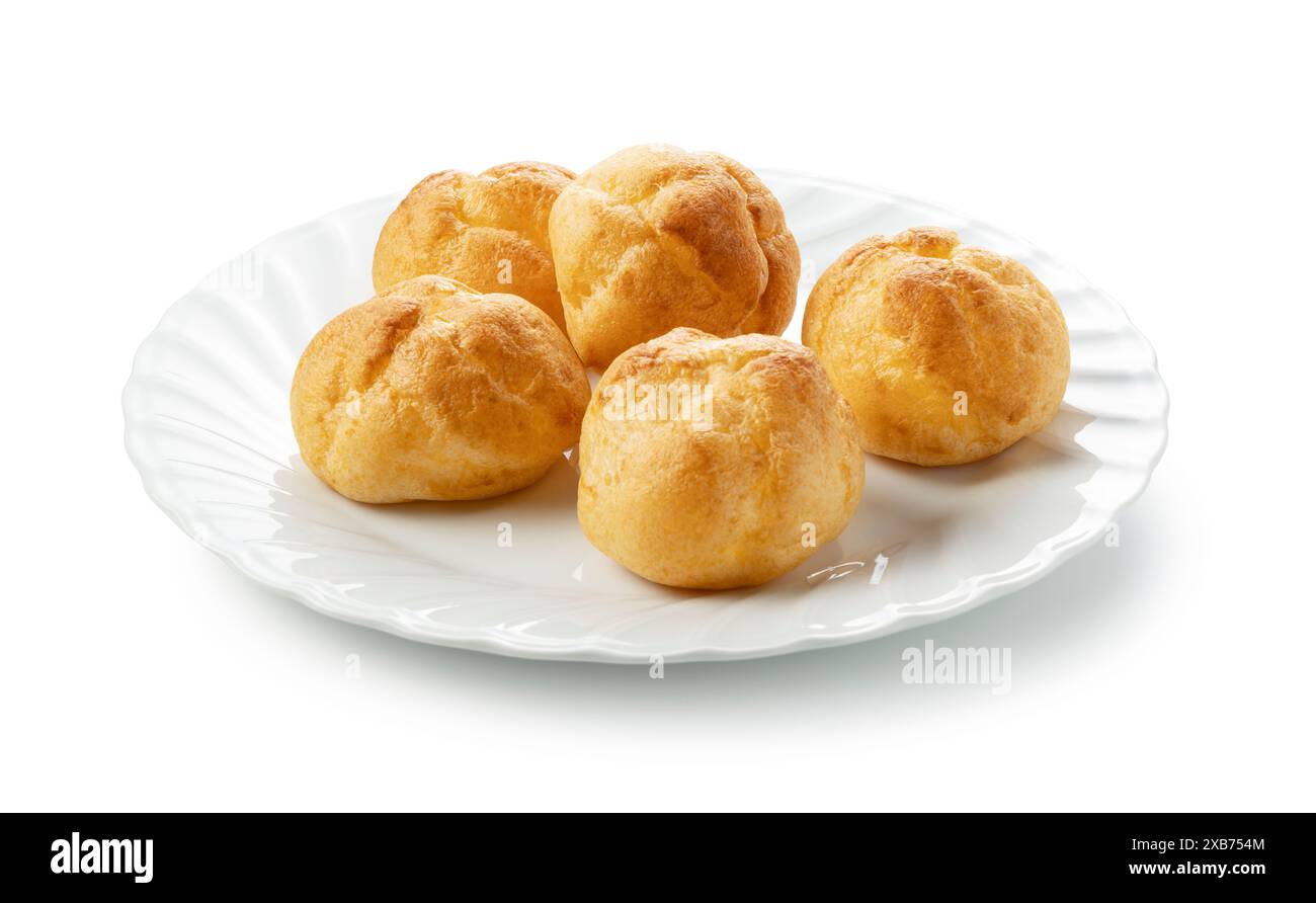 Cream puffs on a plate placed on a white background Stock Photo - Alamy