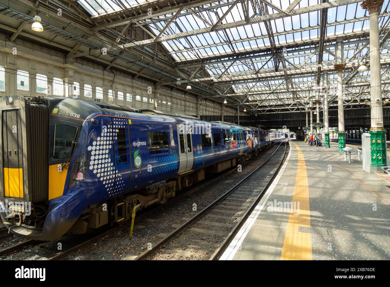 A Scotrail train at a platform at Edinburgh Waverley Train Station ...