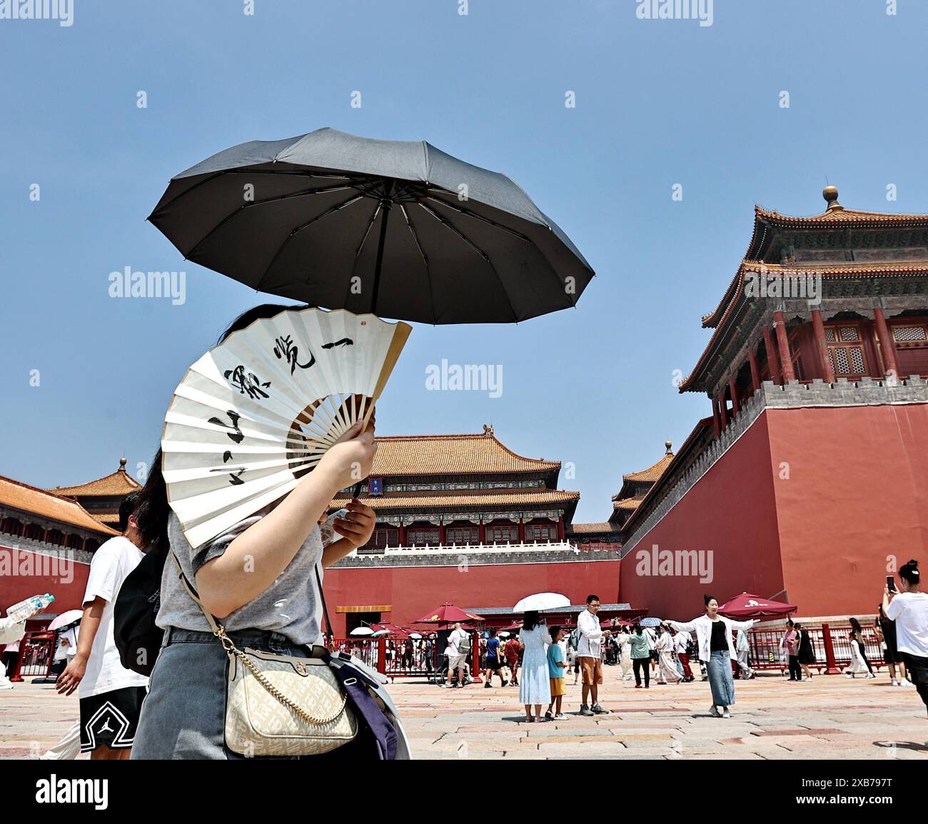 Tourists visit the Palace Museum amid hot weather in Beijing, China, 8 ...