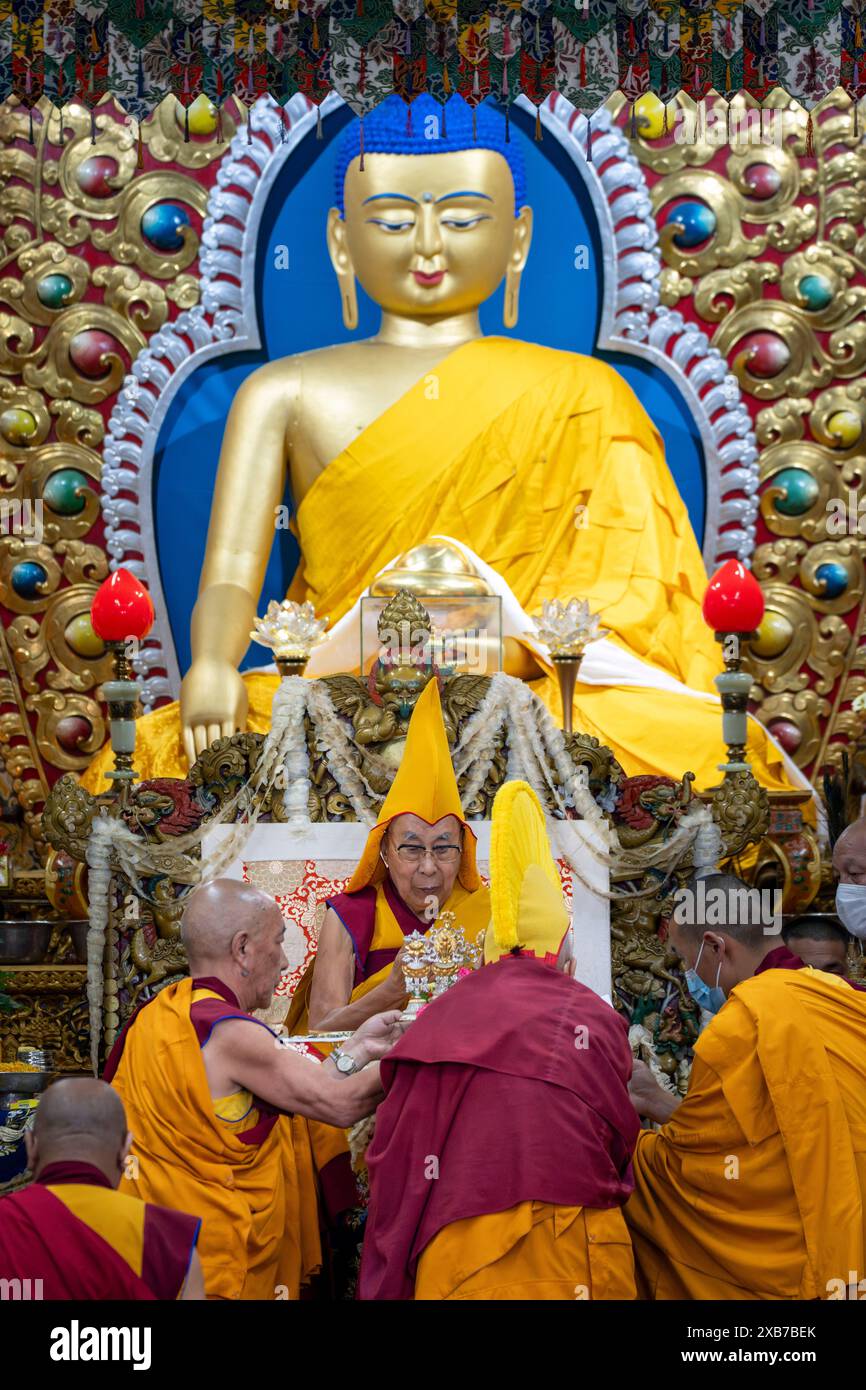 Tibetan spiritual leader the Dalai Lama sits on his ceremonial chair as ...