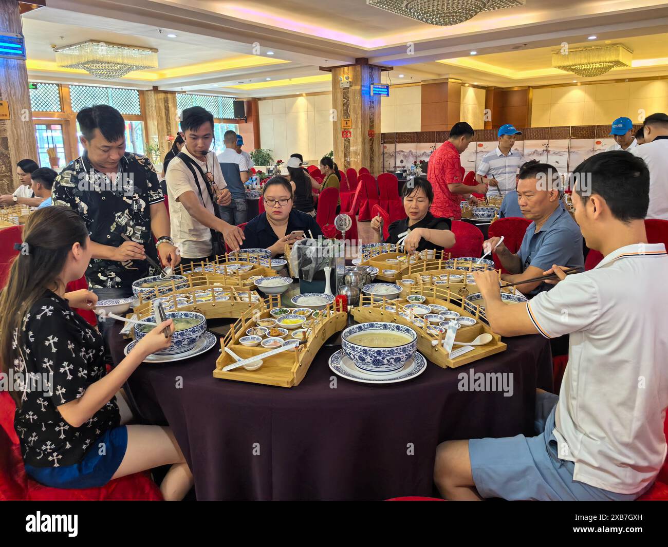 Beijing, China. 11th June, 2024. A group of Vietnamese tourists taste ...