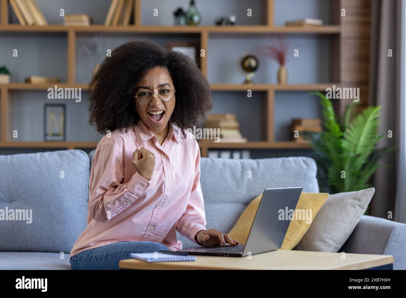 Woman celebrates success working hi-res stock photography and images ...