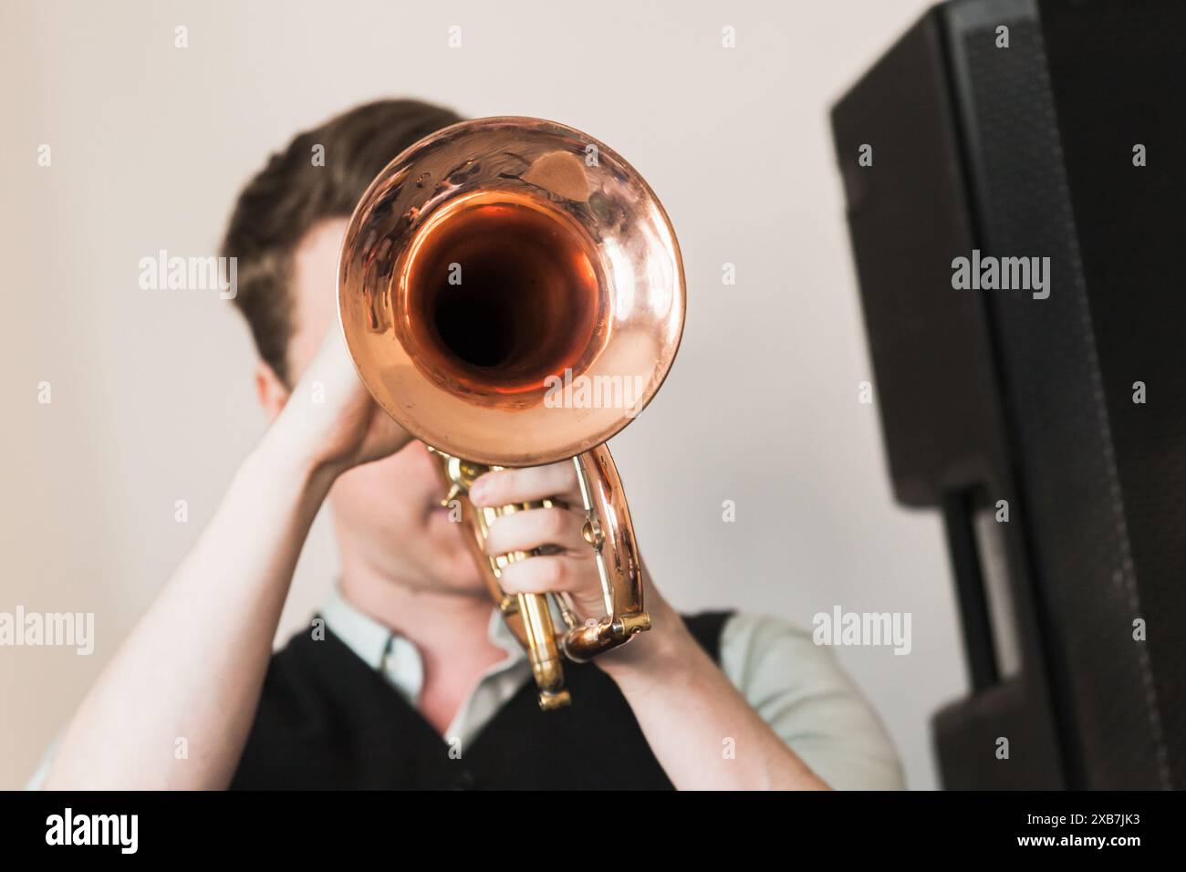Trumpeter with a trumpet in hands, close-up front view photo with ...