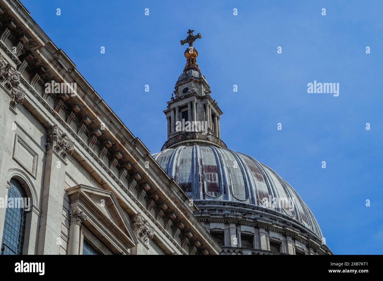 A dome structure with a cross on top attached to a grand cathedral with ...
