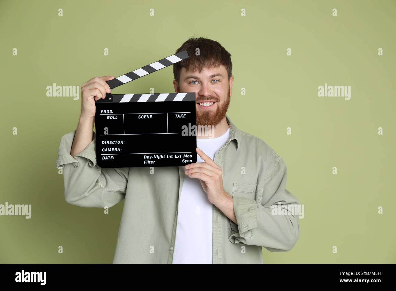 Making movie. Smiling man with clapperboard on green background Stock ...