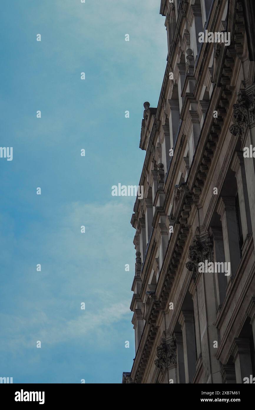 A Tall building flanked by decorative pillars Stock Photo - Alamy