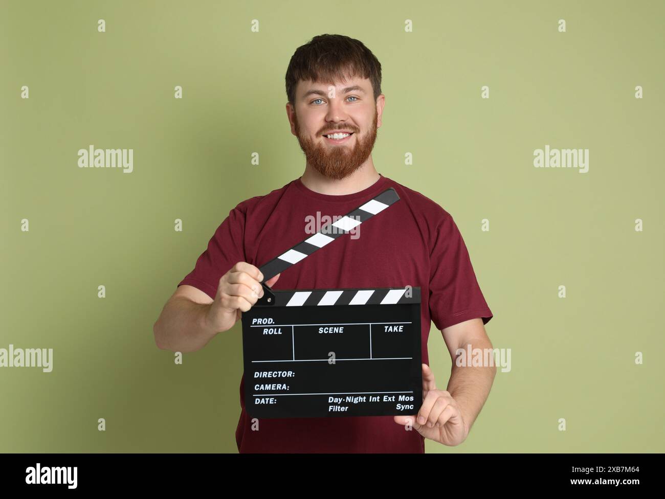 Making movie. Smiling man with clapperboard on green background Stock ...