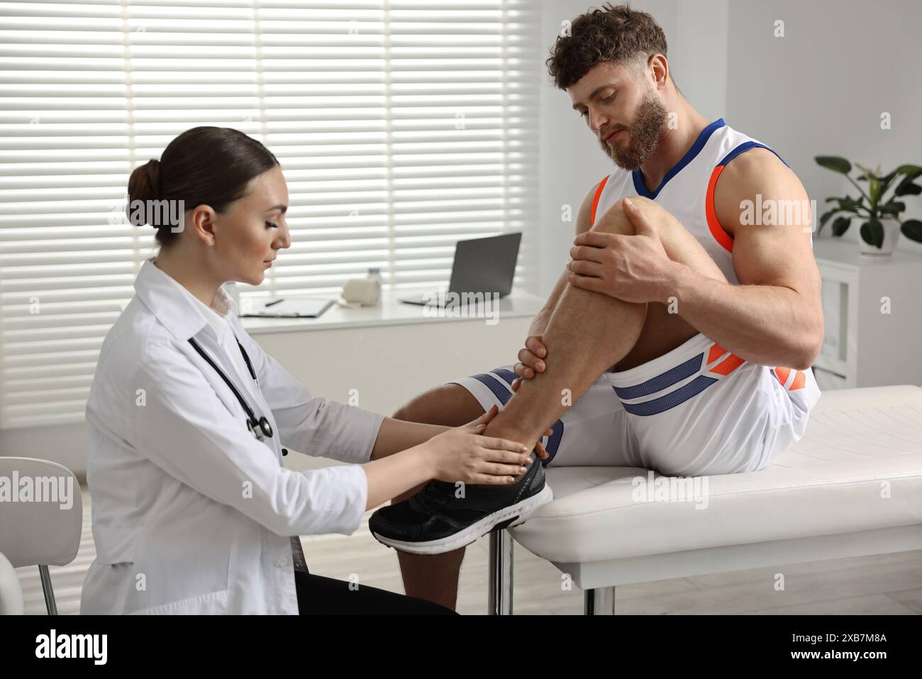 Woman doctor examining leg in hi-res stock photography and images - Alamy