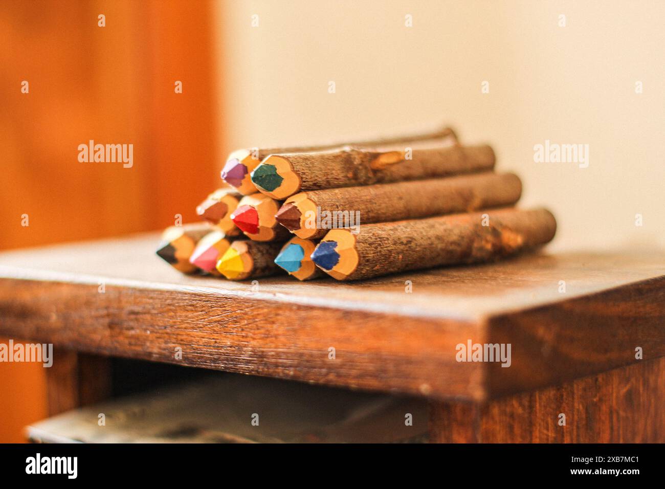 Color pencils neatly arranged on a compact table Stock Photo - Alamy