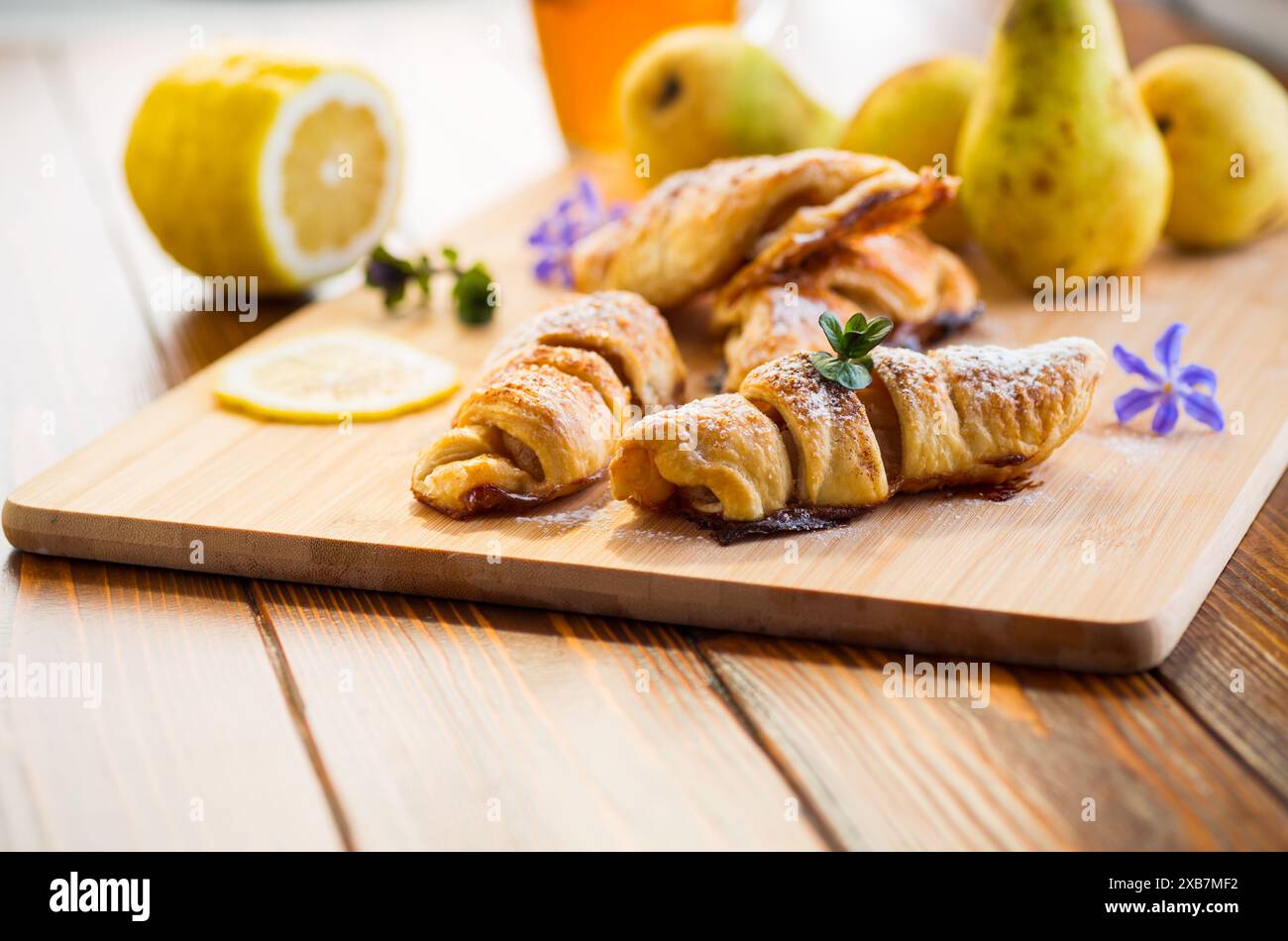 Sweet pastries, puff pastries with pears, on a wooden table Stock Photo ...