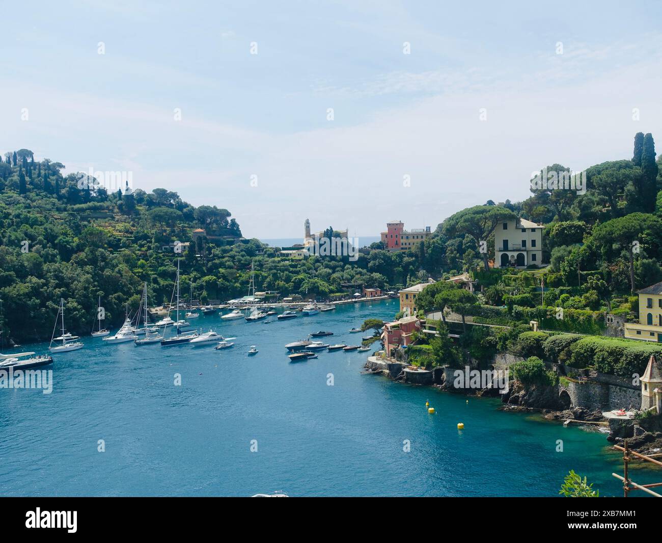 Multiple Boats on water with hilly background with old colorful houses ...