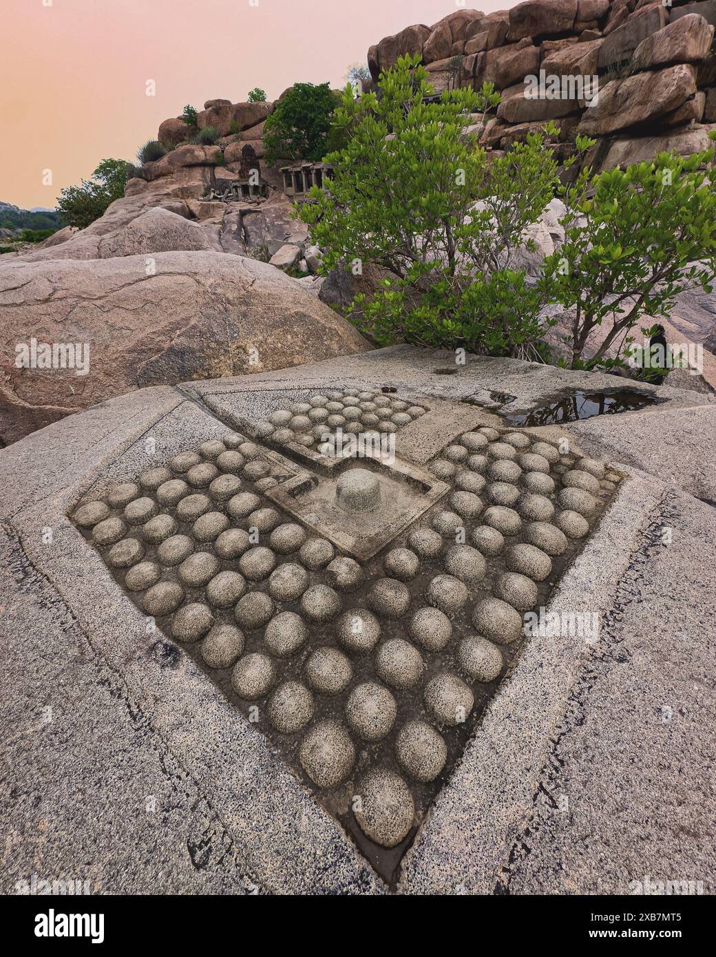 A group of detailed spherical rocks on top of a rocky outcrop with ...
