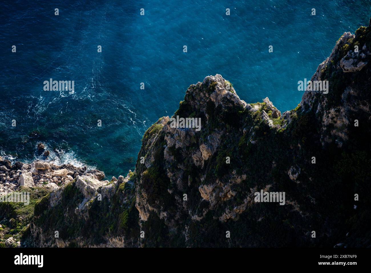 Large Rock formations and forest-covered mountain cliffs near blue ...