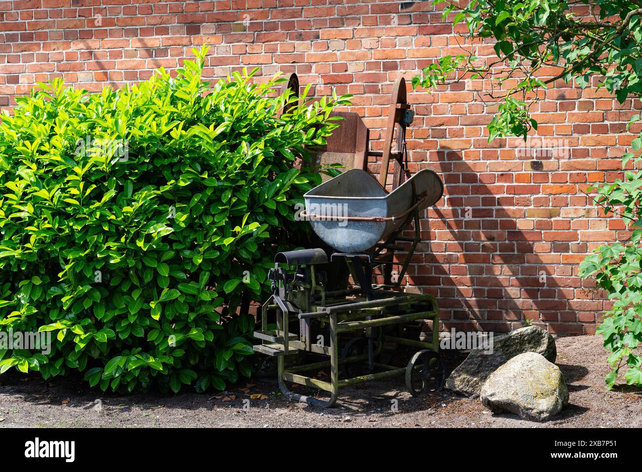 Old robust fashioned wheelbarrow and scales made of solid iron at a ...
