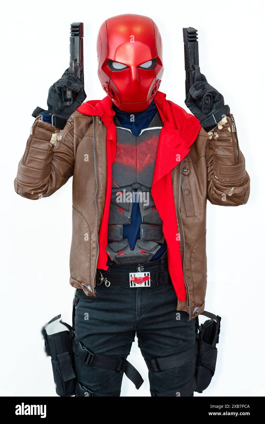 A male cosplayer dressed in red highlights and a red hood, holding a ...