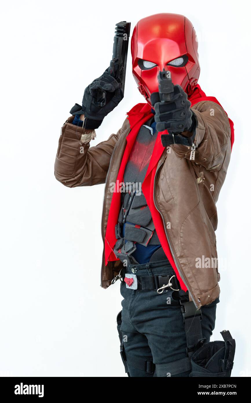 A male cosplayer dressed in red highlights and a red hood, holding a ...