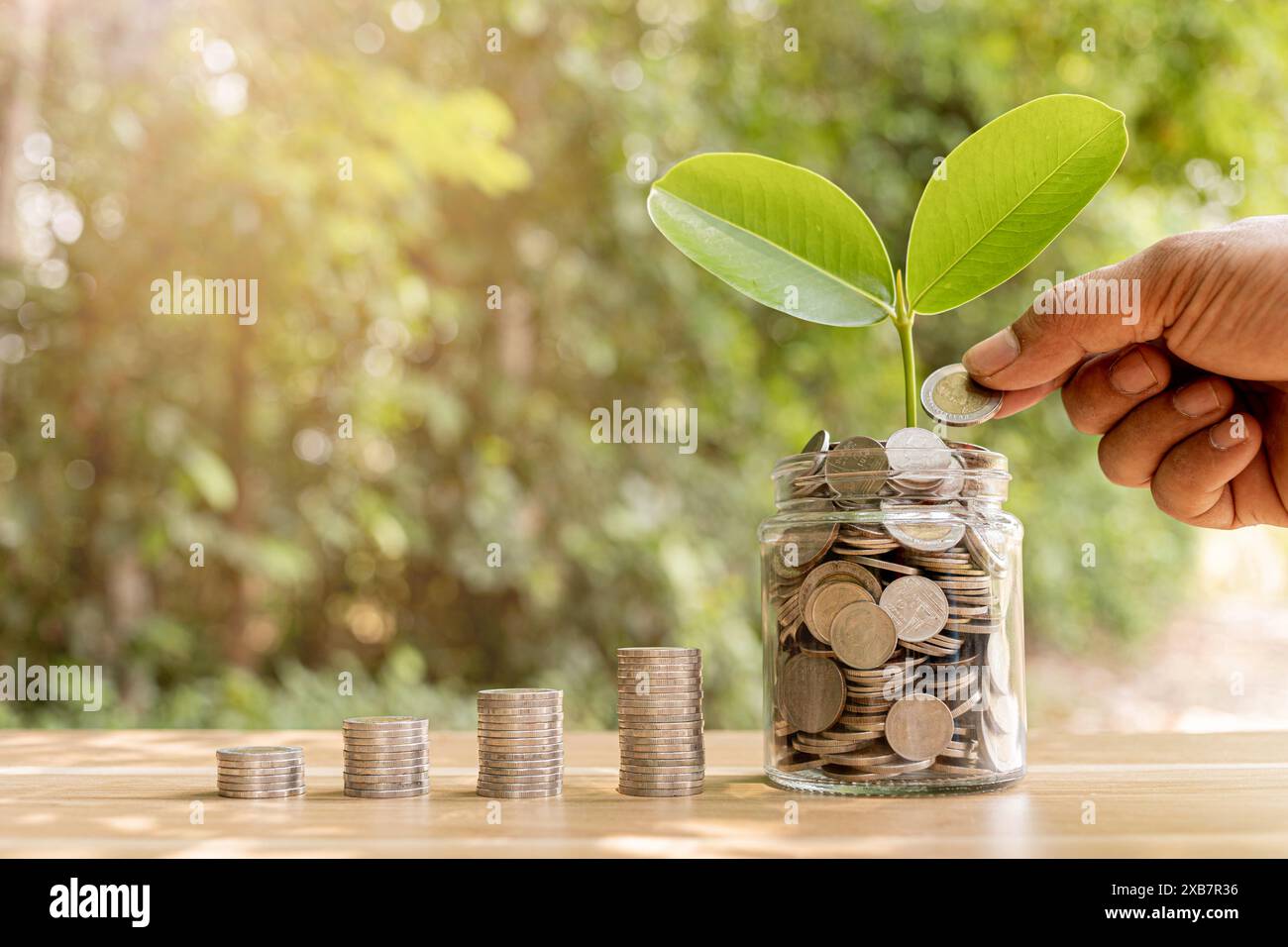 Coins in a clear glass jar money saving concept Stock Photo - Alamy