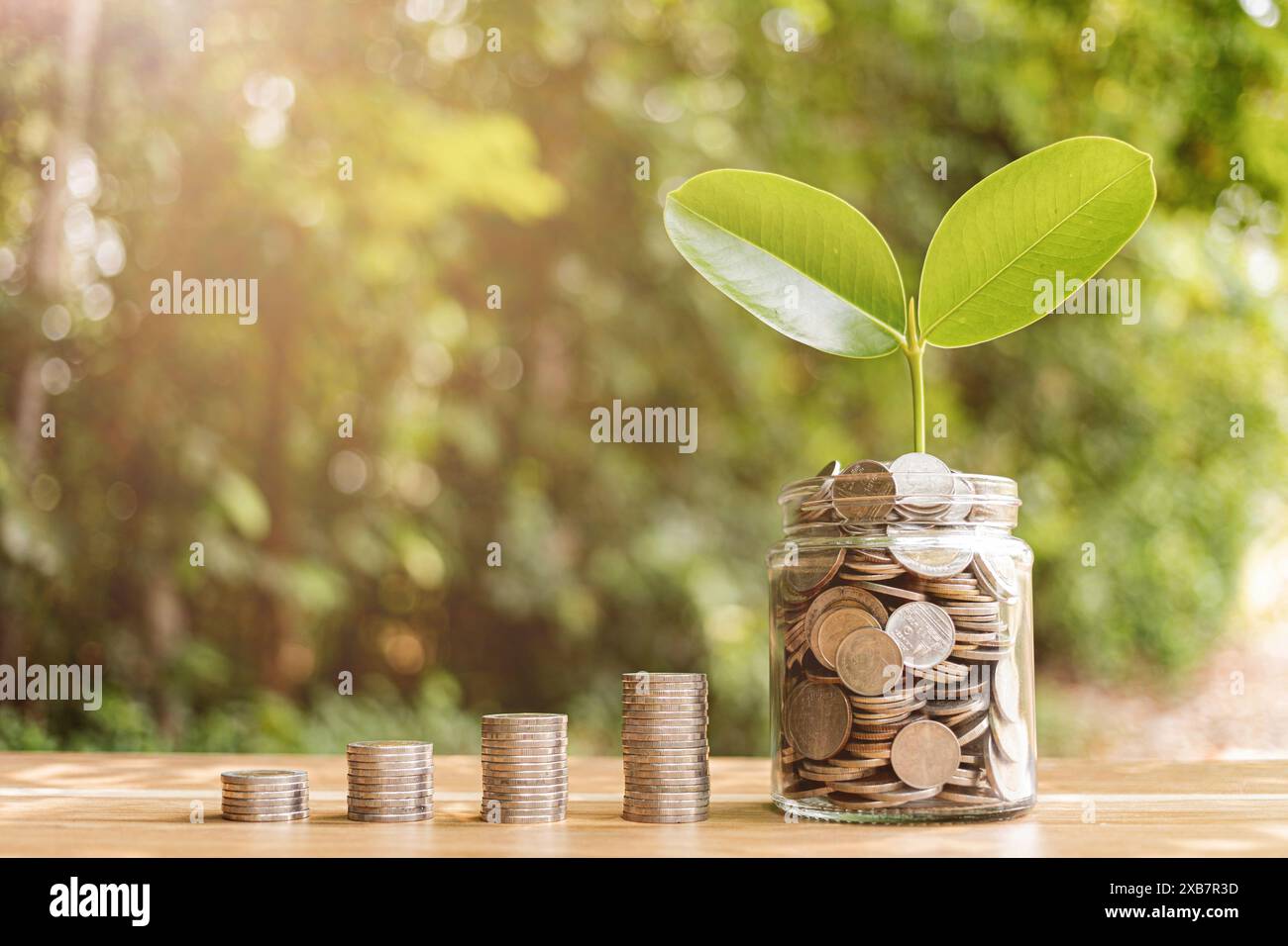 Coins in a clear glass jar money saving concept Stock Photo - Alamy