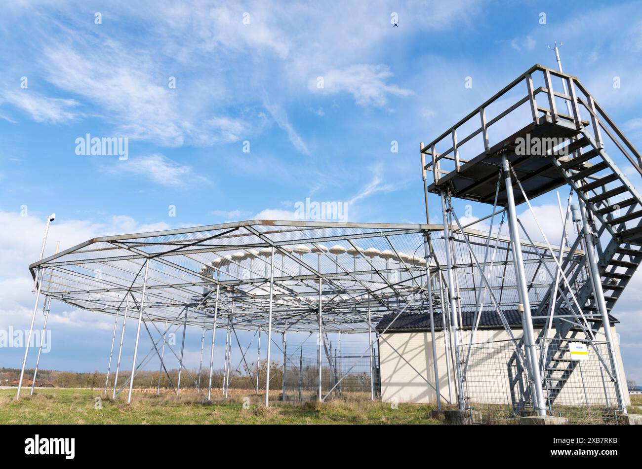 A circular architectural structure under overcast sky with ascending ...
