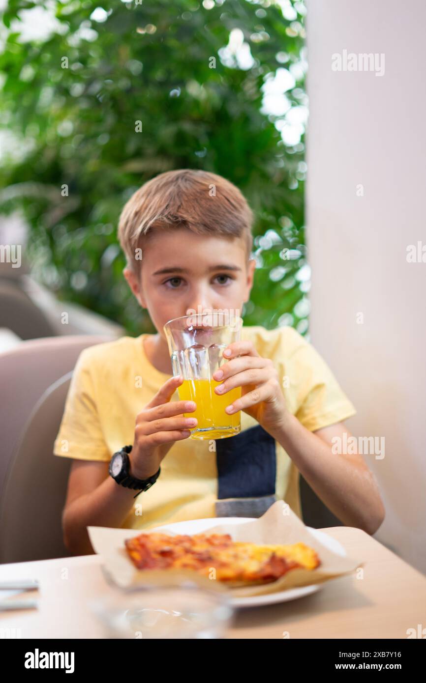 8 year old Caucasian boy drinking an orange soda Stock Photo - Alamy