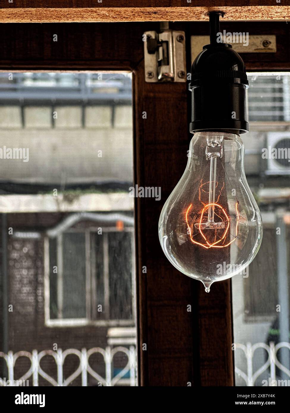 A vintage light bulb illuminating an ancient home Stock Photo - Alamy