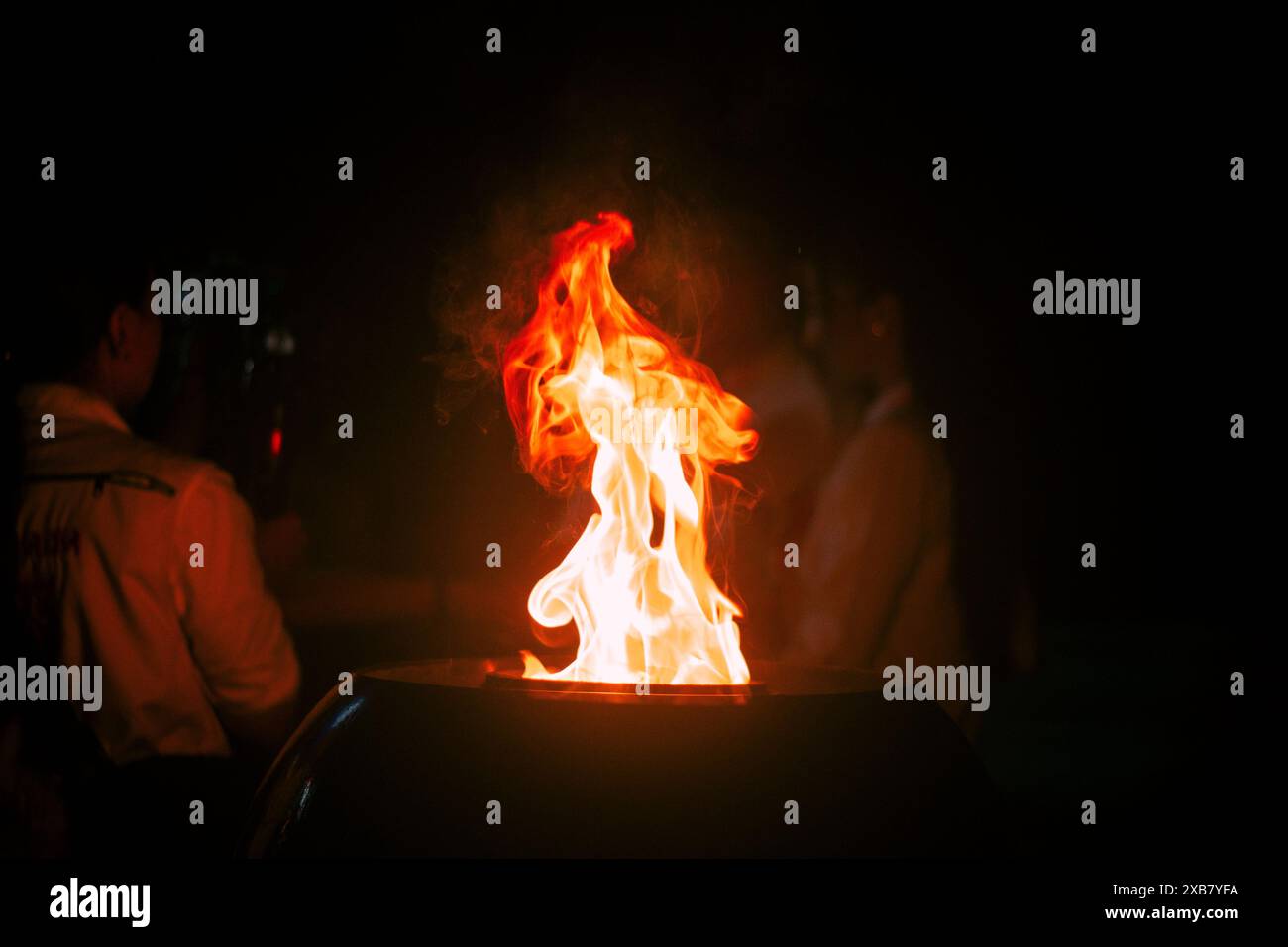 A fire pit with flames burning Stock Photo - Alamy