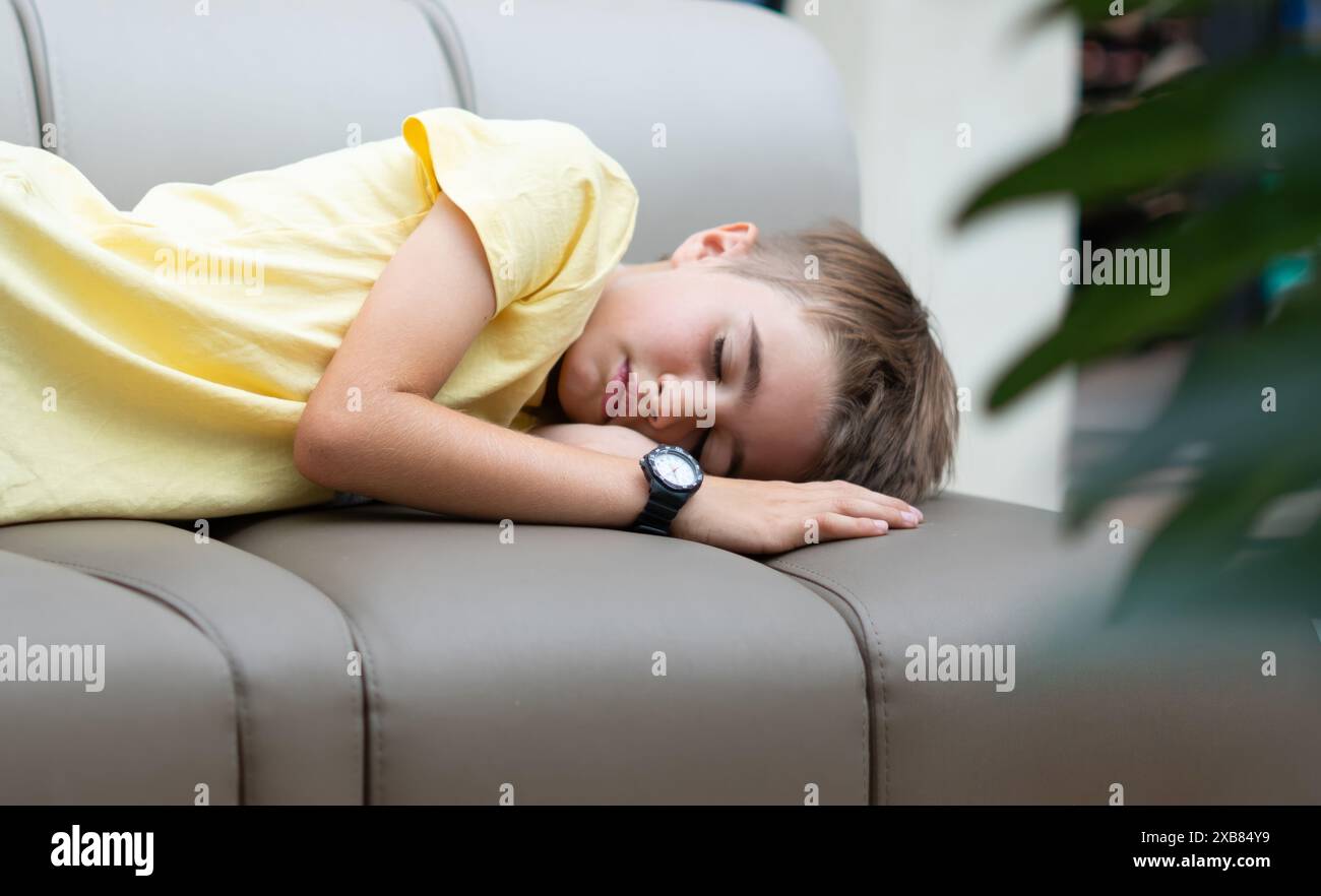 Tired boy sleeping on a sofa Stock Photo - Alamy