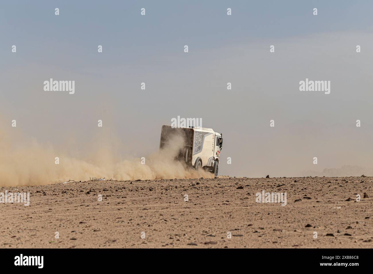Truck driving in desert, kicking up dust from tires Stock Photo - Alamy