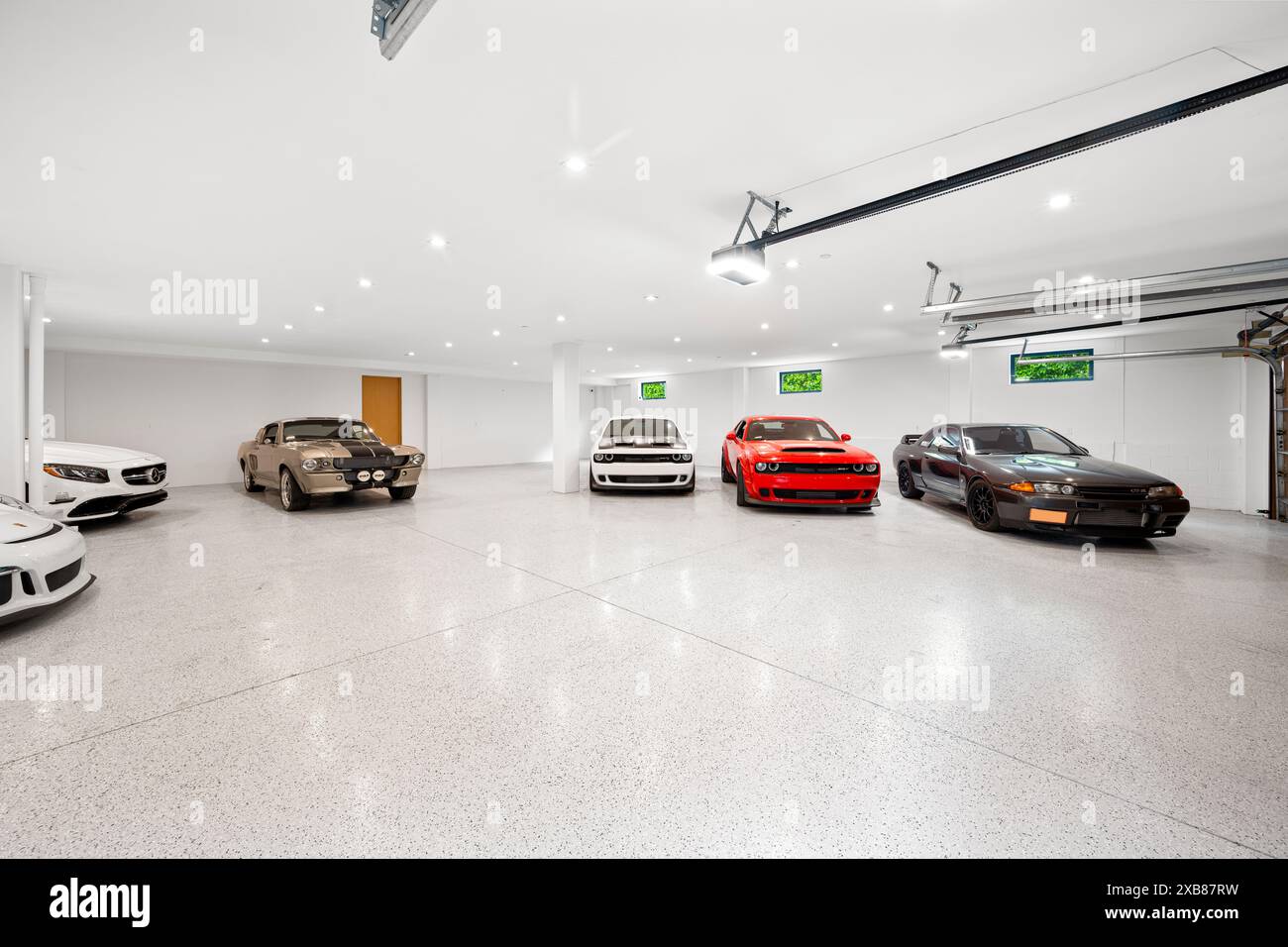 A group of luxurious cars parked inside a room with white walls Stock ...