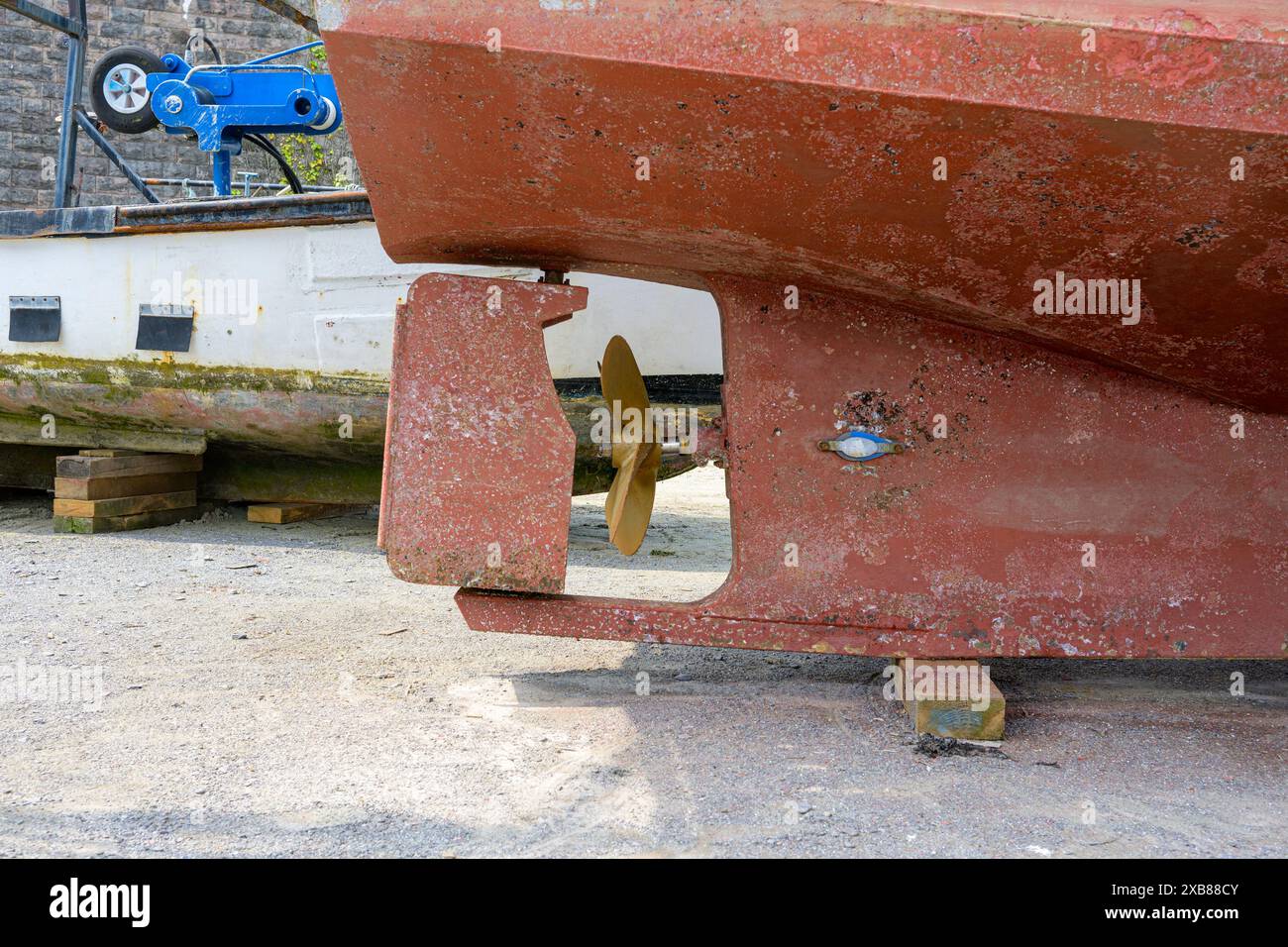 Old, weathered fishing boat's propeller and rudder on dry dock for ...