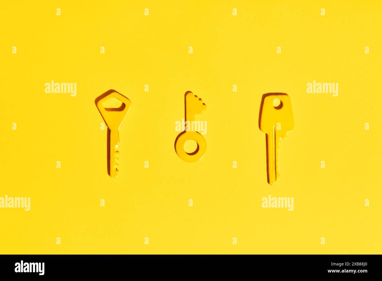 Yellow keys on vibrant yellow background. Flat lay Stock Photo - Alamy