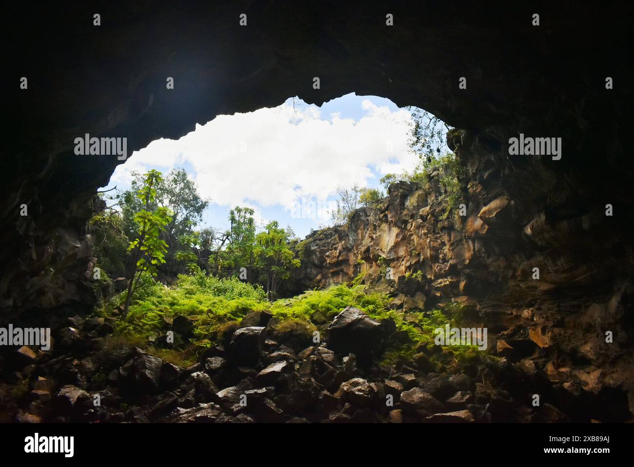 A cave filled with rocks illuminated by bright light from within Stock ...